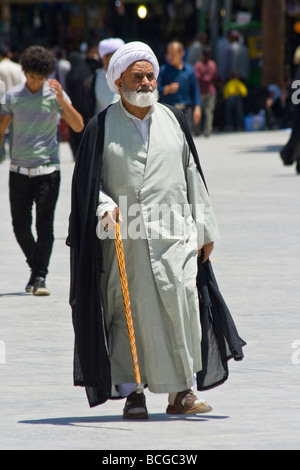 Shia Muslim mullah in turban and gown seated at prayer in the Masjed-e ...