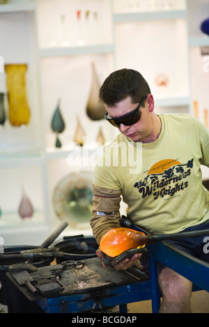 Colin Hawkins, glass blower at the Loco glass studio creating blown ...