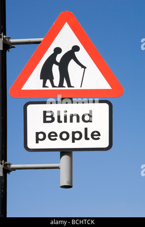 Red warning triangle and a woman walking towards her broken car on the ...