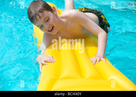 Boy relaxing on float in pool Stock Photo: 43588352 - Alamy
