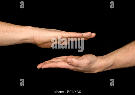 male hands enclosing and encompassing and cupping against black Stock ...