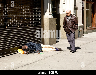 Homeless man sprawled out on 5th Avenue in New York City Stock Photo ...