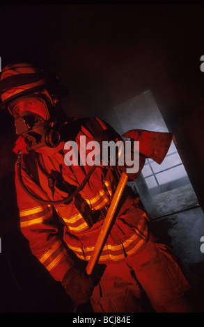 Firefighter in a smoke-filled training room Stock Photo - Alamy