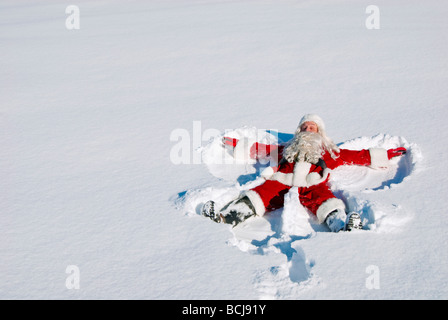 Santa making a snow angel in fresh snow Stock Photo - Alamy