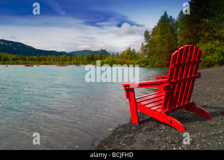 Red Adirondak chair along lakeshore, Alaska Stock Photo - Alamy