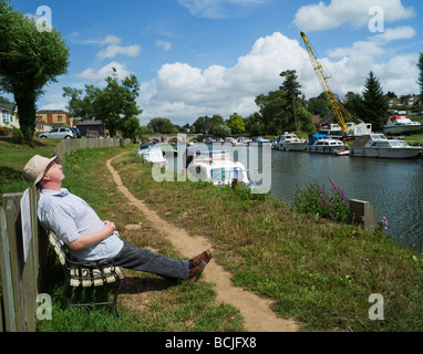 Man resting at river Stock Photo - Alamy