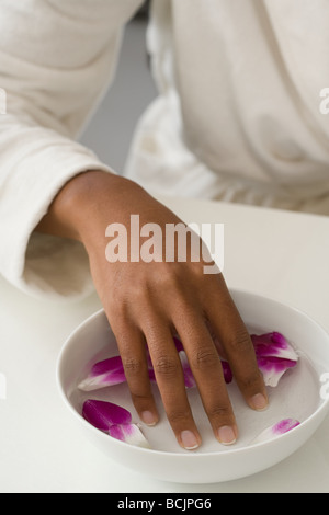 Woman soaking her nails in nail bowls Stock Photo - Alamy