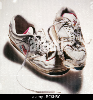 One old and worn shoe with hole on sole on white background Stock Photo ...