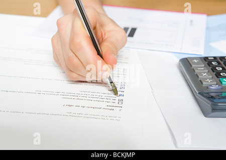 A female filling in a form Stock Photo: 24207068 - Alamy