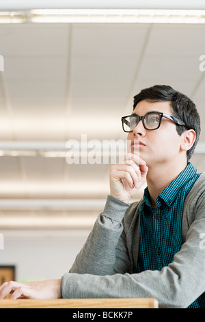 Smart schoolboy teenager in a glasses hold the chalkboard with the ...