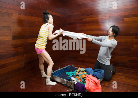 Two woman fighting for clothes Stock Photo - Alamy