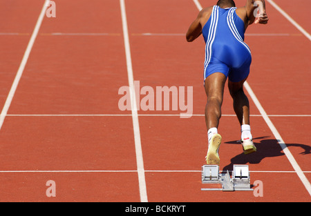 Runner at starting block, rear view Stock Photo - Alamy
