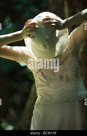 young woman hiding face with straw hat Stock Photo - Alamy