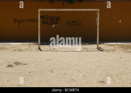 A rough, dirt football pitch with the Rock of Gibraltar in the ...