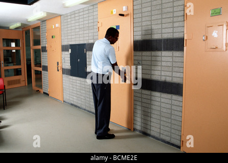 A prison guard locking a prison cell door Stock Photo - Alamy