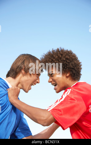 Two young men screaming each other Stock Photo - Alamy