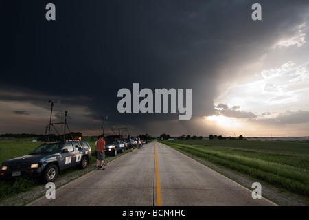 Storm chasers with Project Vortex 2 line up along a highway in rural ...