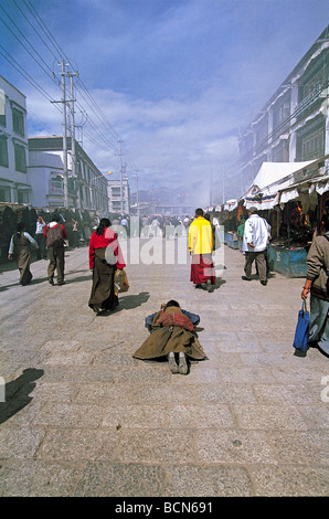 Tibetan pilgrim make full-body prostration toward mountains, Ngari ...
