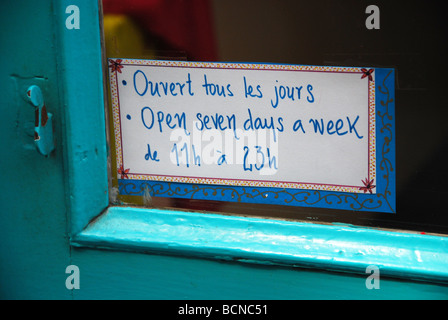 sign indicating business hours of French shop Stock Photo - Alamy