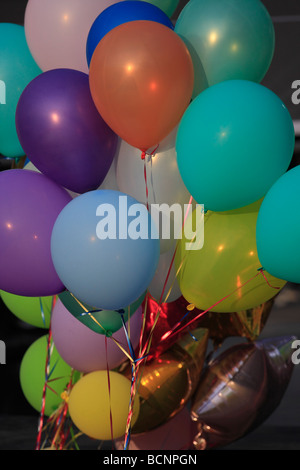 Helium balloons tied to a string Stock Photo - Alamy