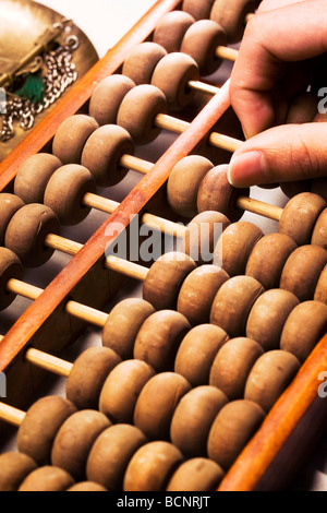 Hand using Chinese traditional calculator abacus Stock Photo - Alamy