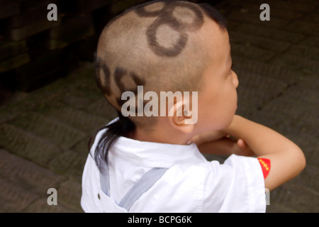 Chinese boy with Olympic logo hair cut, Beijing, China Stock Photo - Alamy