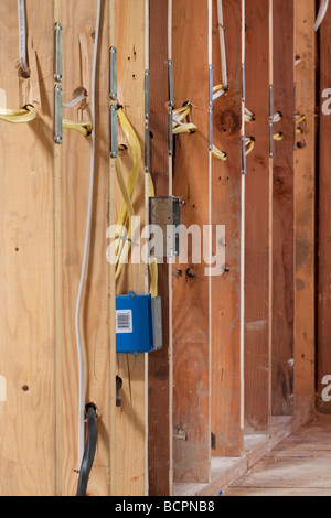 Electrical wires running through wood wall studs at residential Stock ...