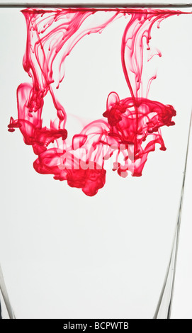 Colored food dye droplets floating in water to make abstract patterns ...