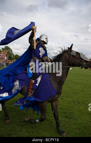 Medieval knight on horseback holding lance and shield during Stock ...