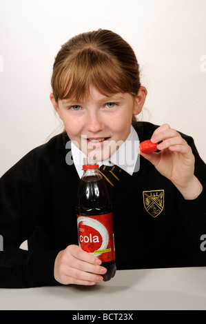 Top view of childs hand holding an orange cup full of wild strawberries ...