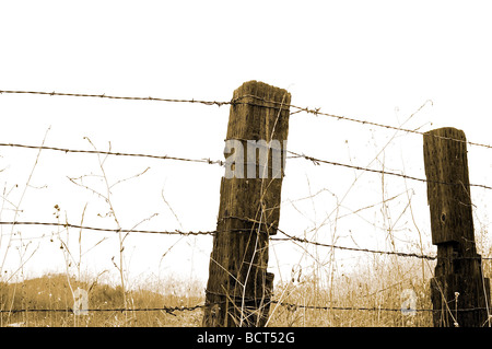 old wooden fence with barbed wire on top Stock Photo - Alamy