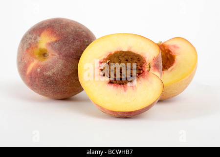 Halved sweet peaches fruit isolated on white background Stock Photo - Alamy