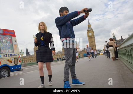 A man takes a photograph outside the Houses of Parliament in London ...