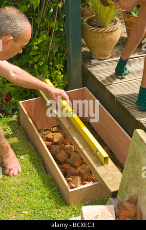 female builder using spirit level outdoors Stock Photo - Alamy