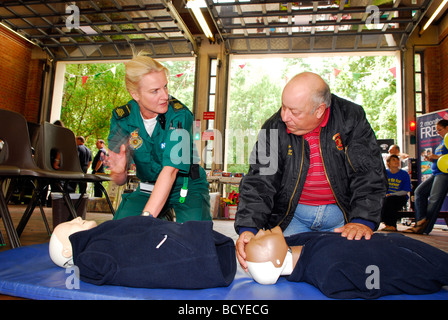 Female paramedic demonstrating CPR [Cardio Pulminary Resuscitation] to ...