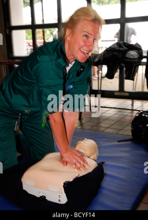 Female paramedic demonstrating CPR [Cardio Pulminary Resuscitation] to ...