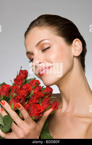 Vertical shot of a Caucasian female model posing in an elegant light ...