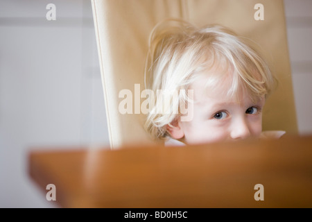 children looking over table edge Stock Photo - Alamy