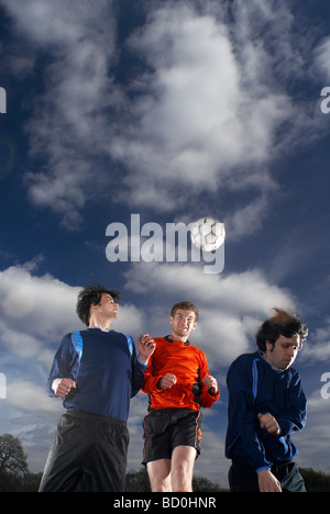 Footballer jumping for header Stock Photo - Alamy