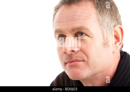 A middle aged Caucasian man in paint stained clothes and cap stands ...