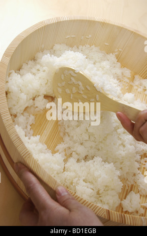 Hand scooping rice in Ohitsu Stock Photo - Alamy