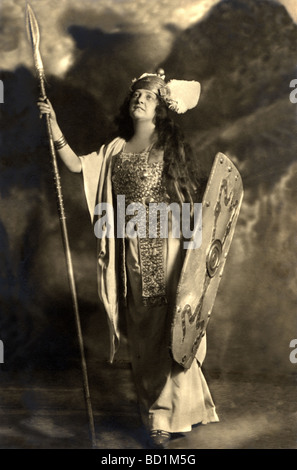 White haired female warrior knight stands with a drawn sword and a ...