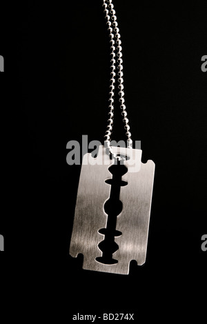 The steel chain is cut by a metal blade on a light gray background. A ...