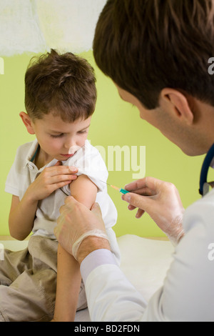 male doctor giving injection to a boy Stock Photo - Alamy