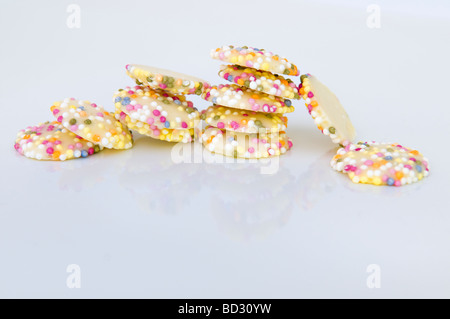 White chocolate buttons with coloured sprinkles or hundreds and ...