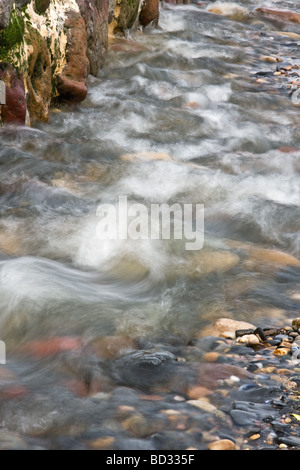 Water flowing over sand and pebbles Stock Photo - Alamy