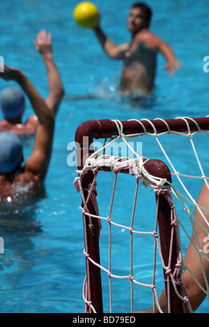 Water polo. Yellow water polo ball in a swimming pool on blue water ...