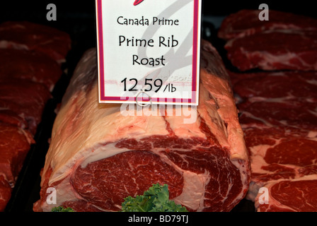 Display cooler case trays of beef steaks roasts sausages marinated ribs ...