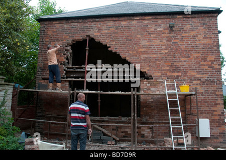 Acro props supporting part of a wall that has collapsed Stock Photo - Alamy