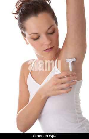 Beautiful brunette woman shaving armpit hair with razor sticking tongue ...